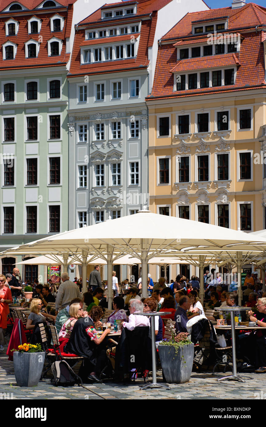 GERMANY Saxony Dresden People sitting at restaurant cafe tables under ...