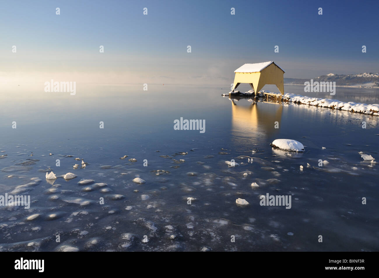 Yellow boathouse out in the frozen sea, winter,seascape, frozen sea ...