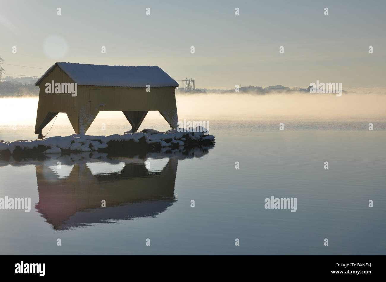 Yellow boathouse out in the frozen sea, winter,seascape, frozen sea ...
