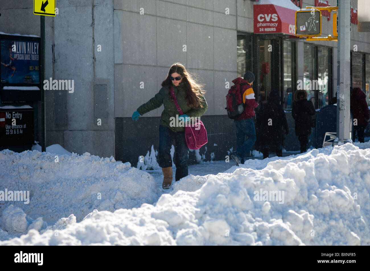 People maneuver through the ever-drifting snow in the Chelsea ...