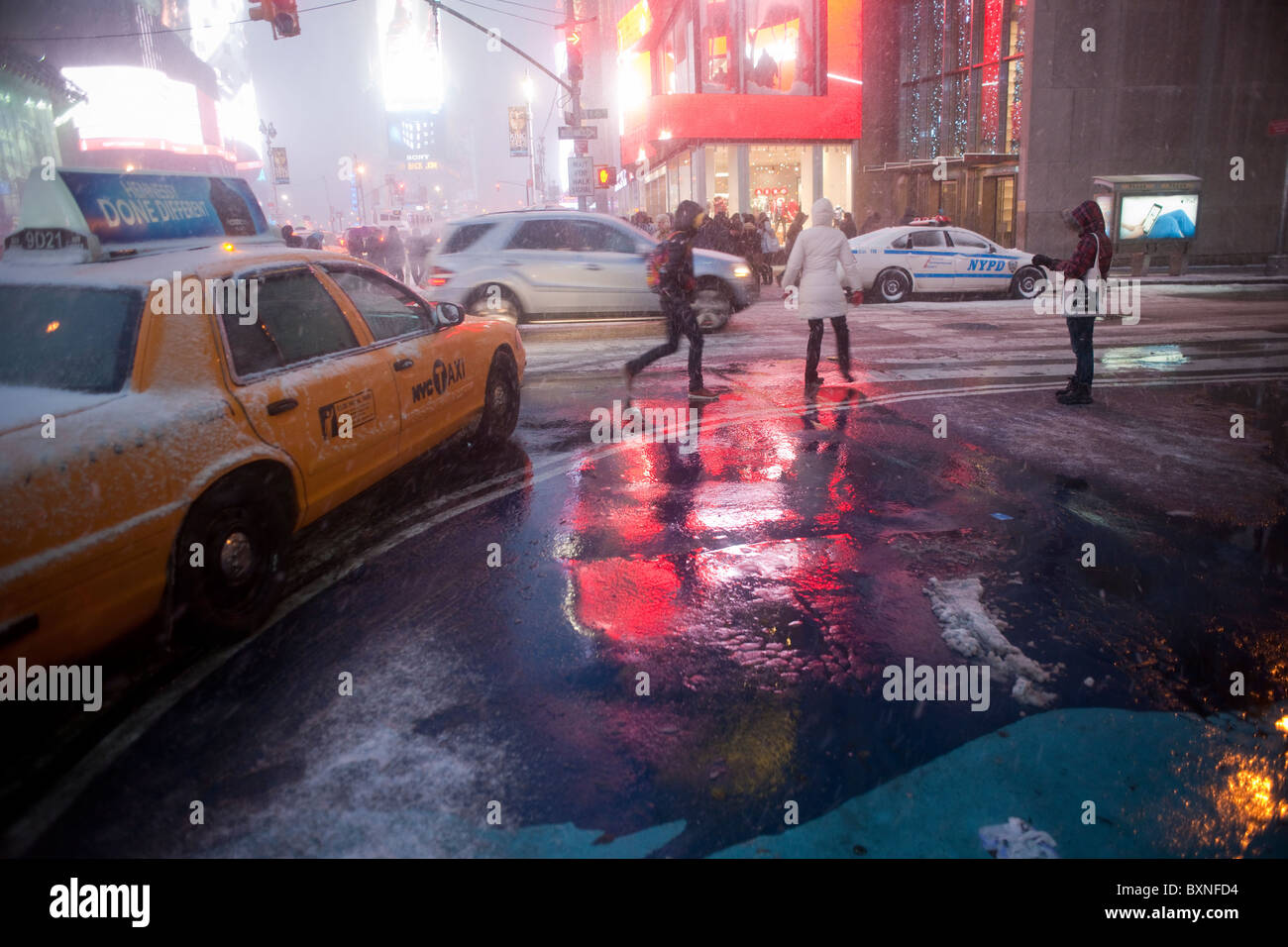 New Yorkers and visitors maneuver through the snow in Times Square in ...