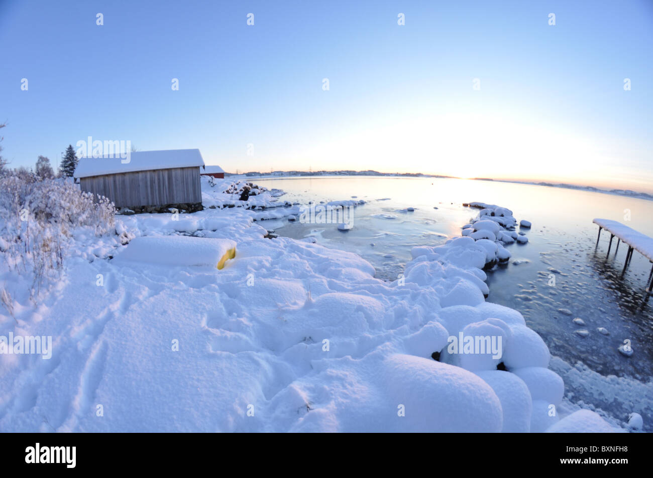 Winter landscape by the sea seen through a fisheye lense. snow, sea ...