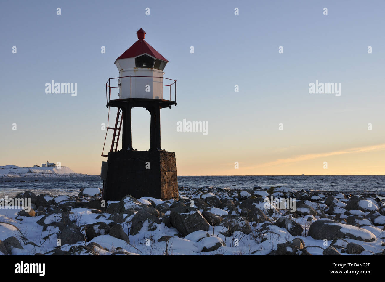Winter landscape with a small lighthouse, stones, snow, blue sky Stock ...