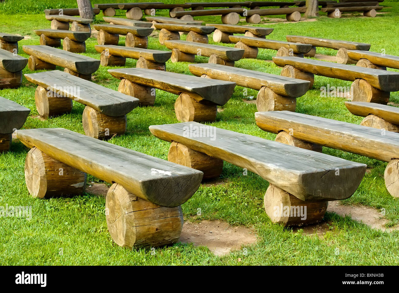 outdoor wood seating on green lawn Stock Photo - Alamy