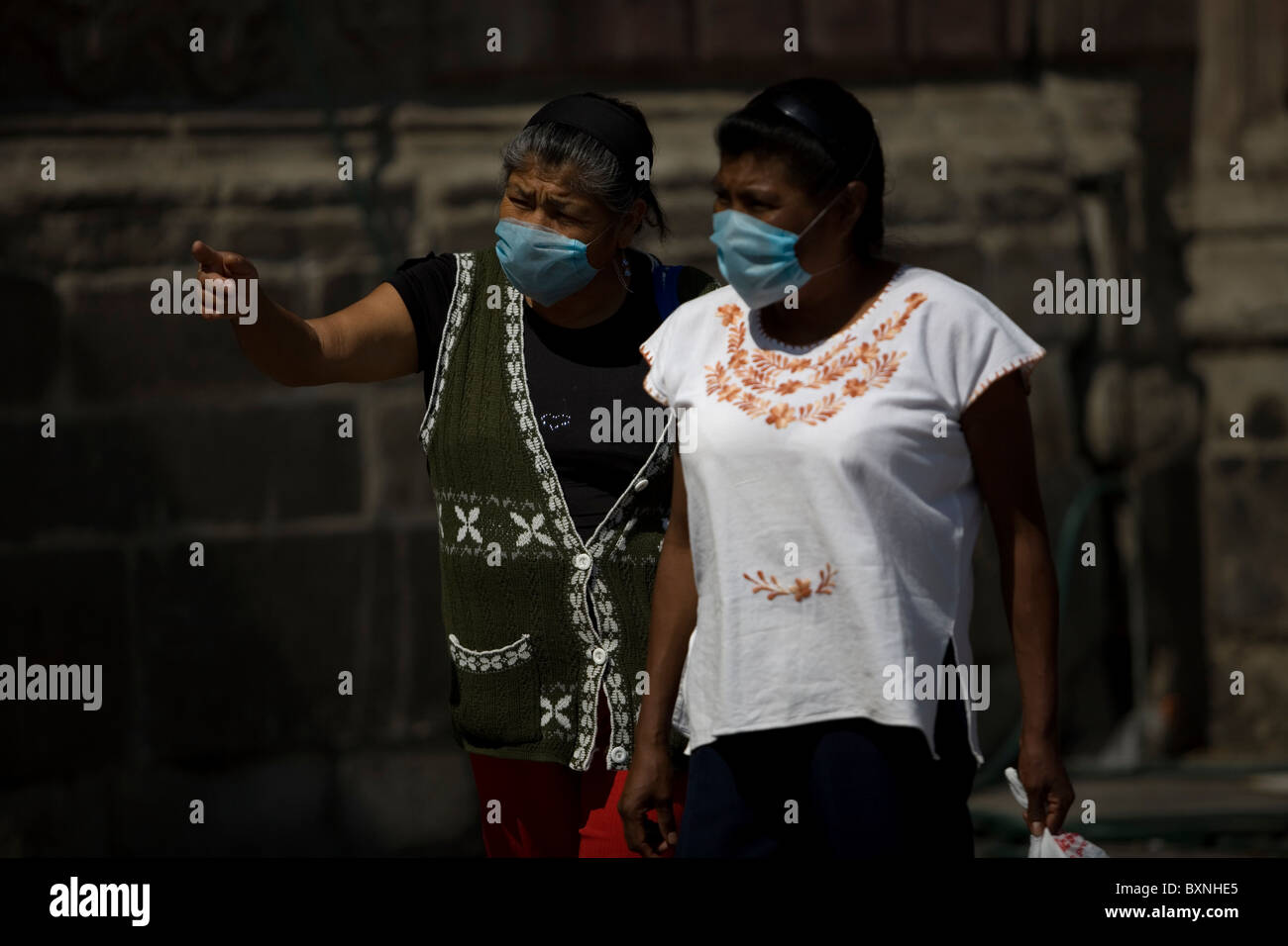 Women wearing masks as a precaution against swine flu walks in Mexico ...