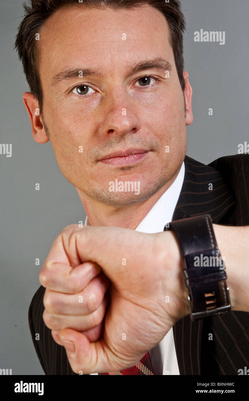 Businessman checking time Stock Photo - Alamy