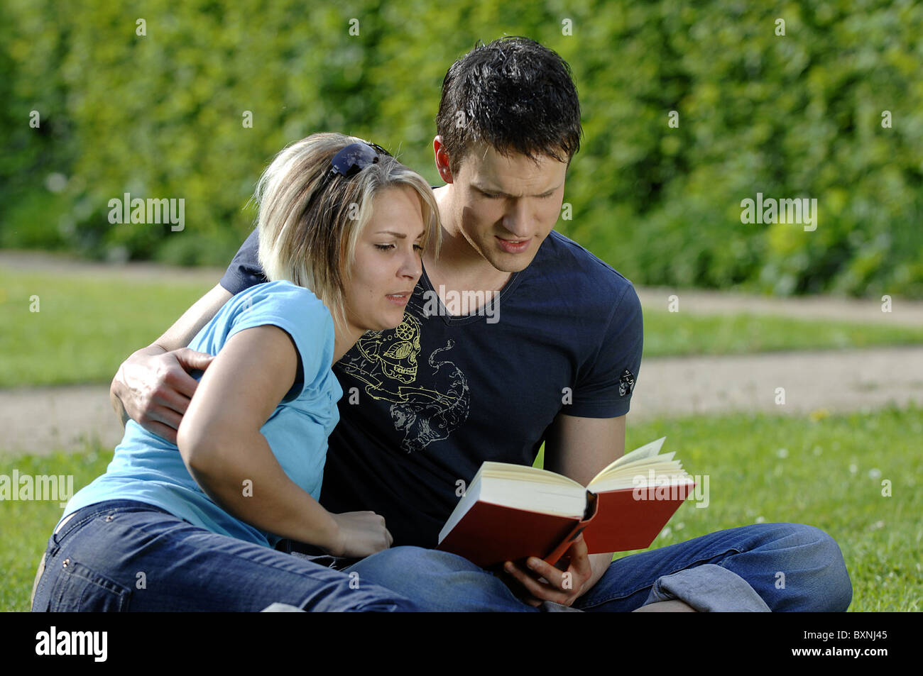 Couple reading a book Stock Photo - Alamy