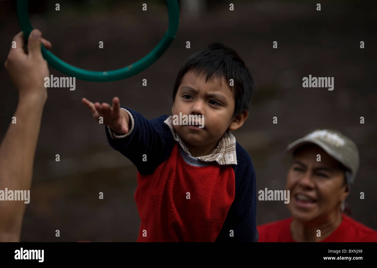 A boy reaches for a hoop during a horse therapy session in Mexico City ...