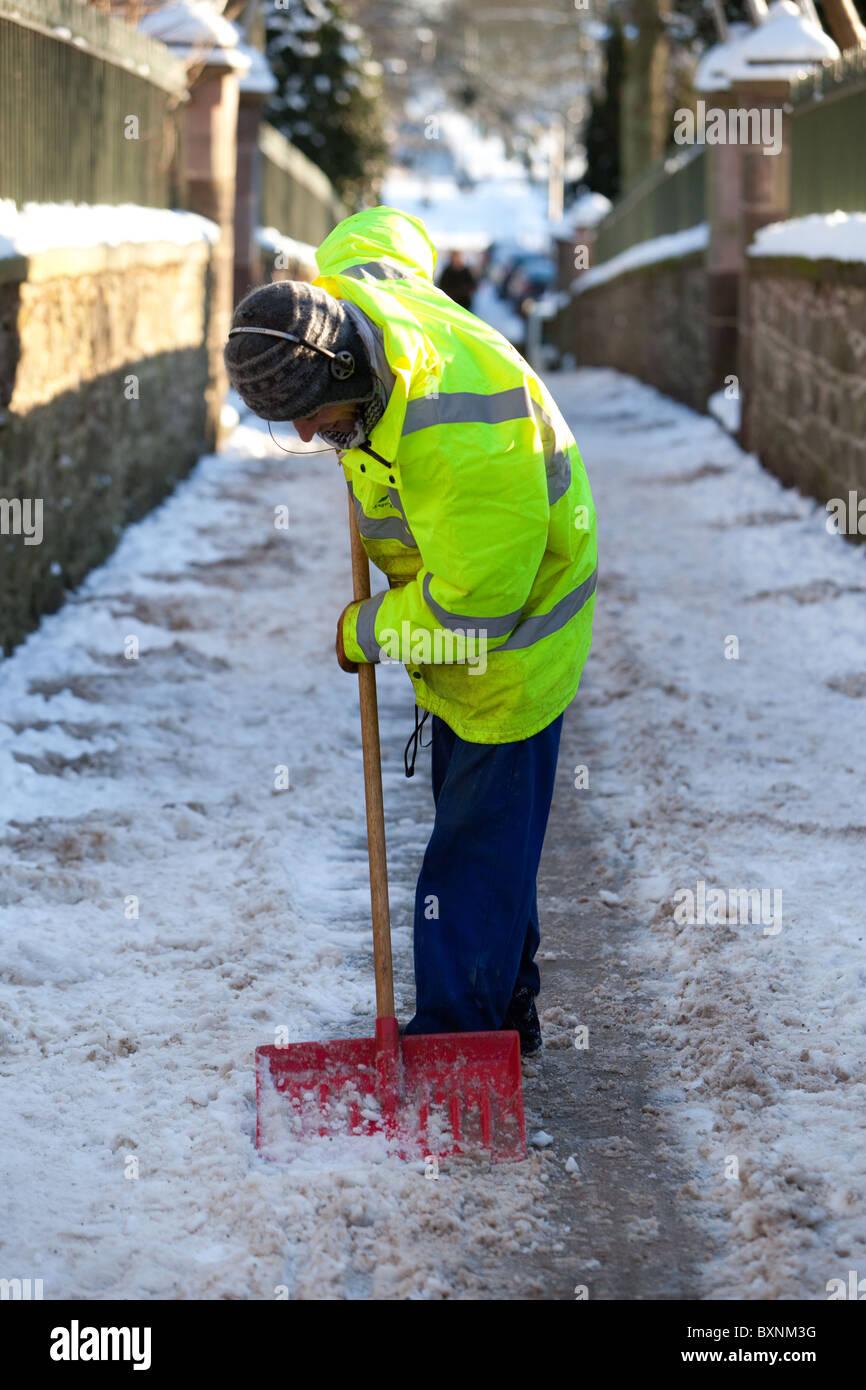 Council workman clearing pavements and paths from Winter Snow for ...