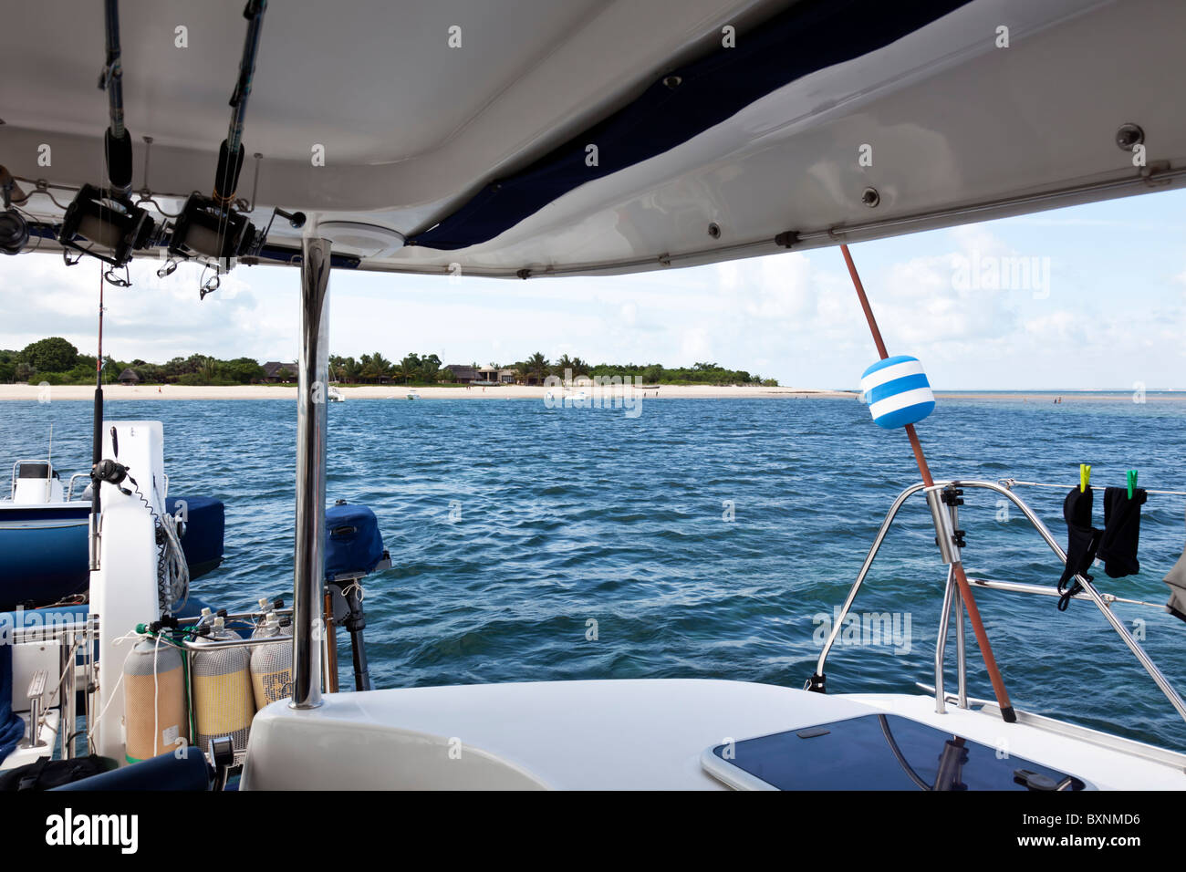 Tropical Island viewed from the back deck of a luxury catamaran yacht ...