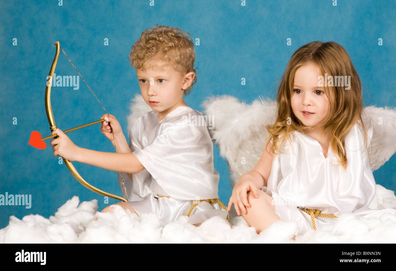 Portrait of two young angels sitting on the cloud Stock Photo - Alamy