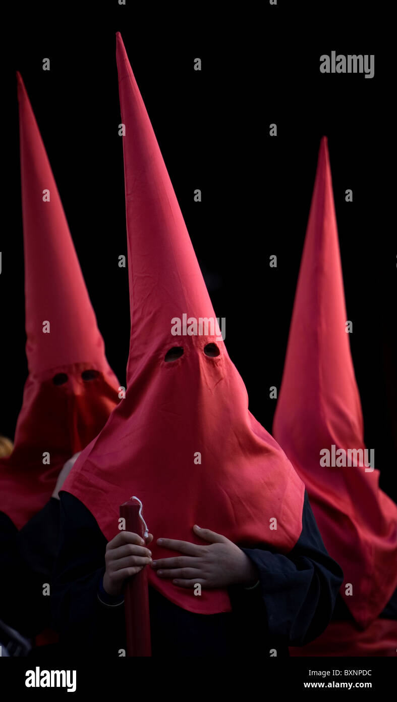 Penitents walk in a street during Easter Holy Week celebrations in ...