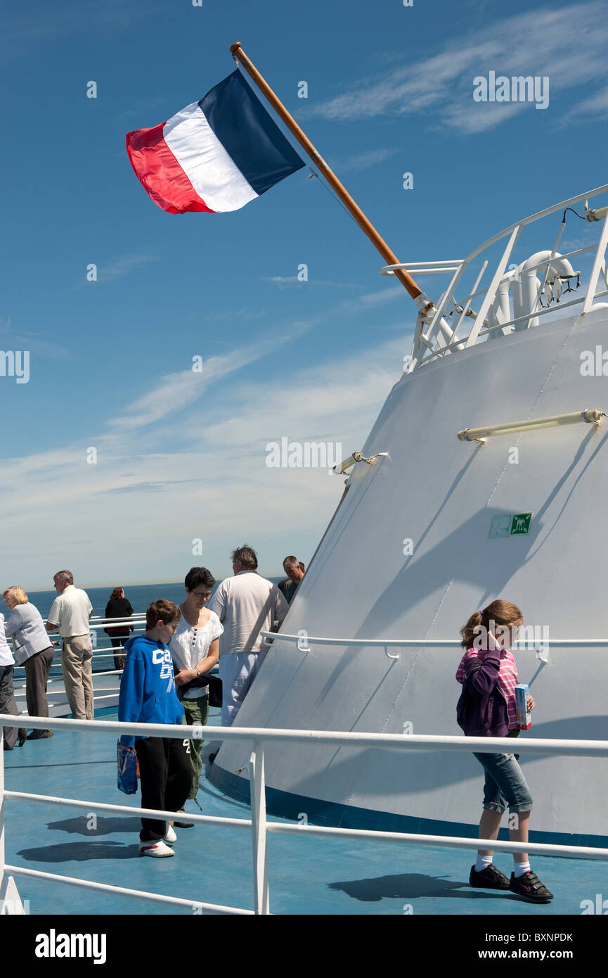 People on Ferry with French Flag Flying against Blue Sky Stock Photo ...
