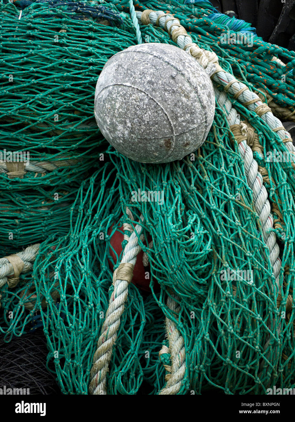 Piles of fishing nets and buoys Stock Photo - Alamy