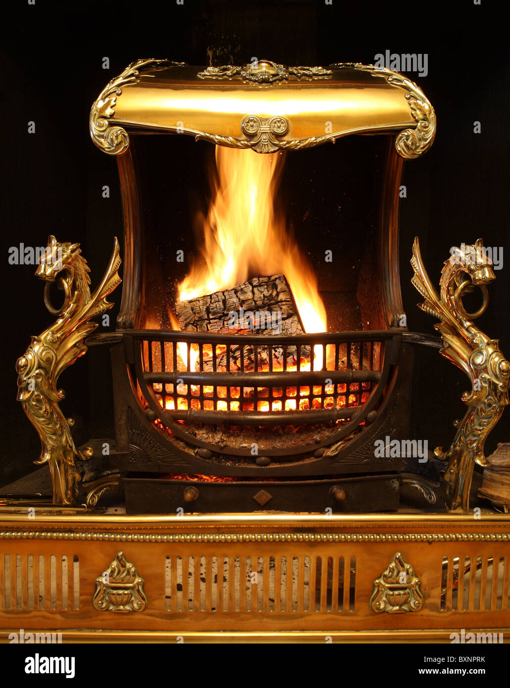 brass fireplace with real wood fire Stock Photo - Alamy