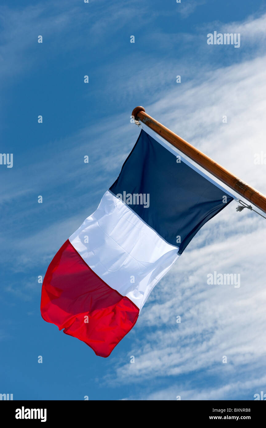 French Flag Flying against Blue Sky Stock Photo - Alamy