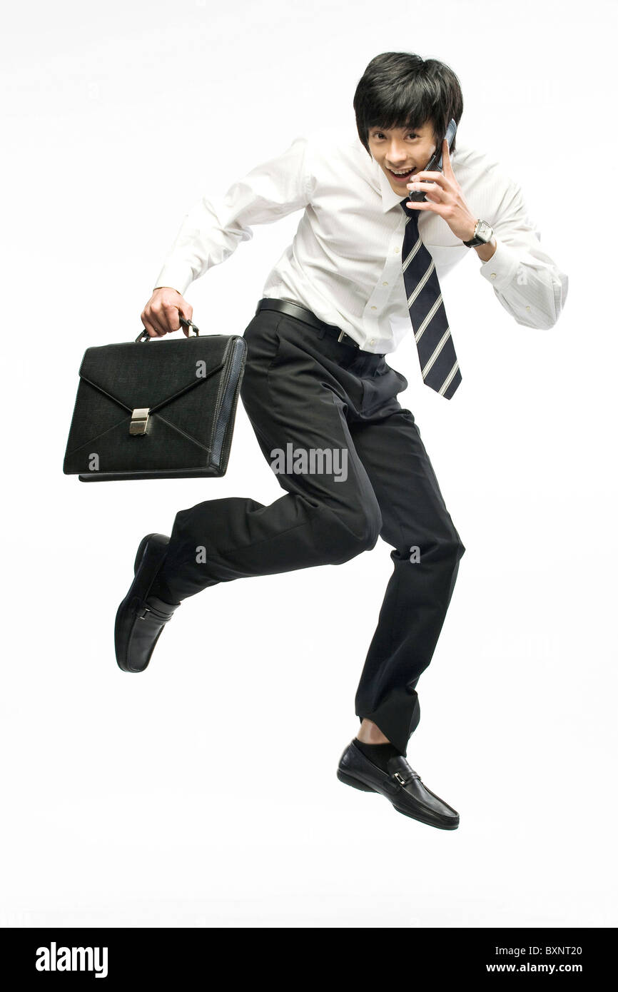 Young businessman carrying briefcase Stock Photo - Alamy