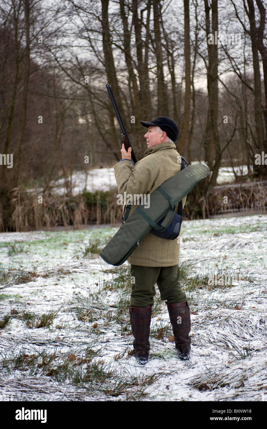 man stands shotgun at ready Stock Photo - Alamy