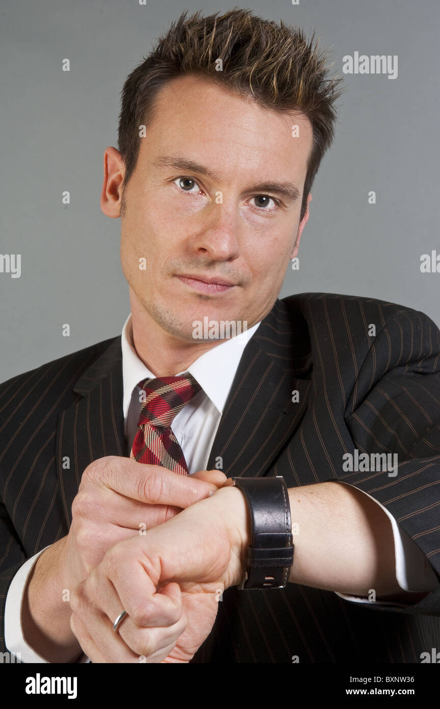 Businessman checking time Stock Photo - Alamy