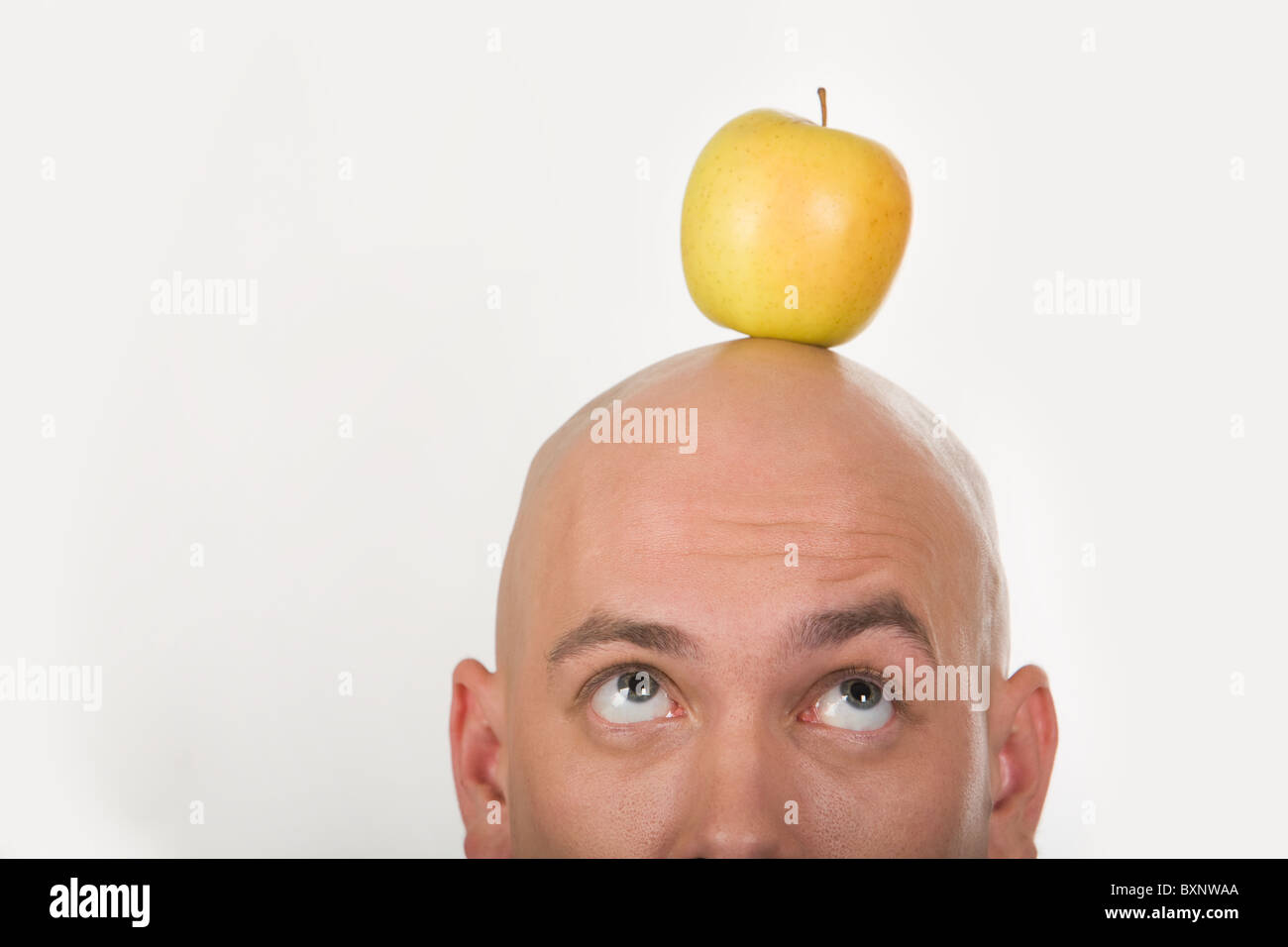 Close-up of bald male head with yellow apple on it Stock Photo - Alamy