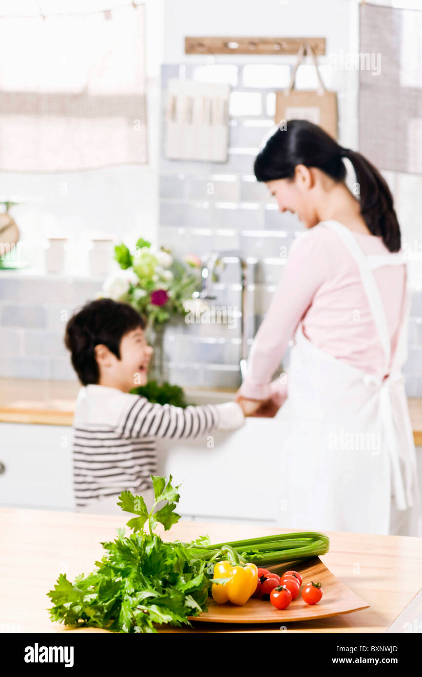 Boy and mother in kitchen Stock Photo - Alamy