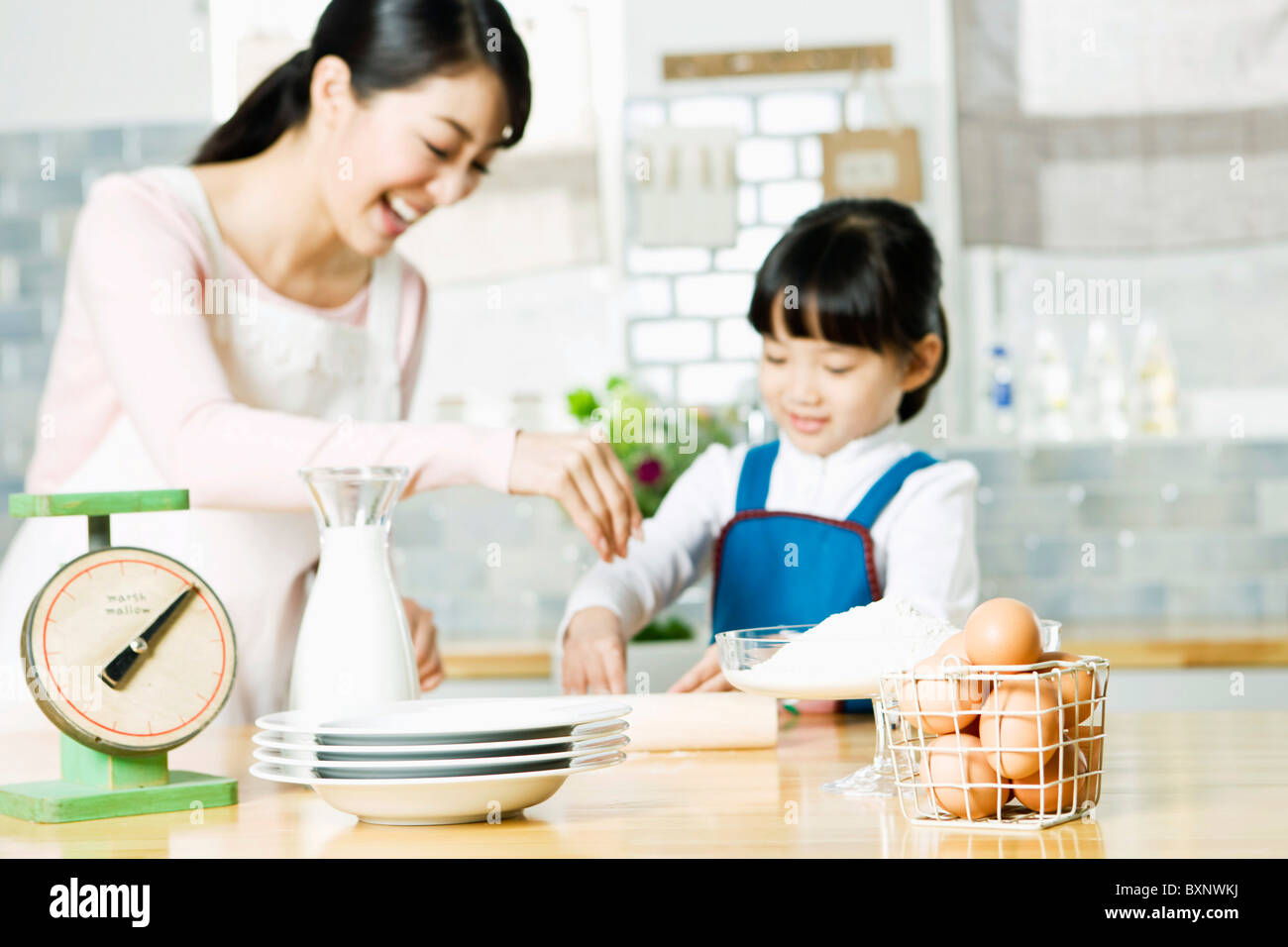 Girl and mother baking in kitchen Stock Photo - Alamy