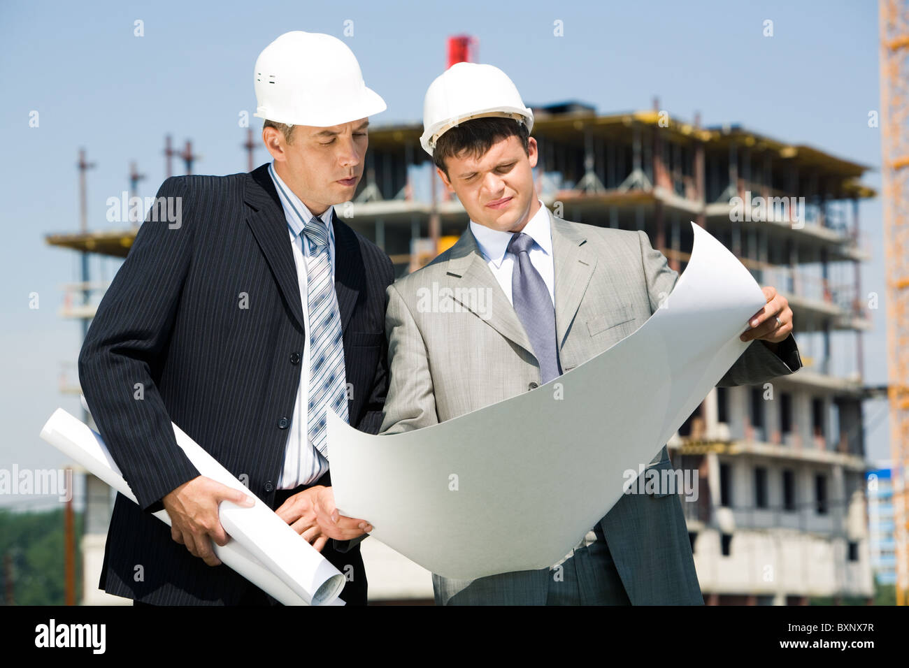 Image of architect and worker looking at architectural project Stock ...