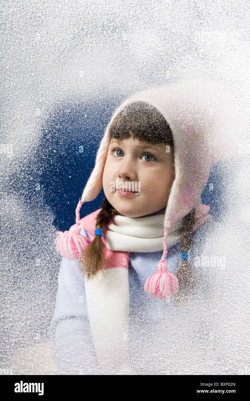 Photo of pretty little girl behind frosted window looking through it ...