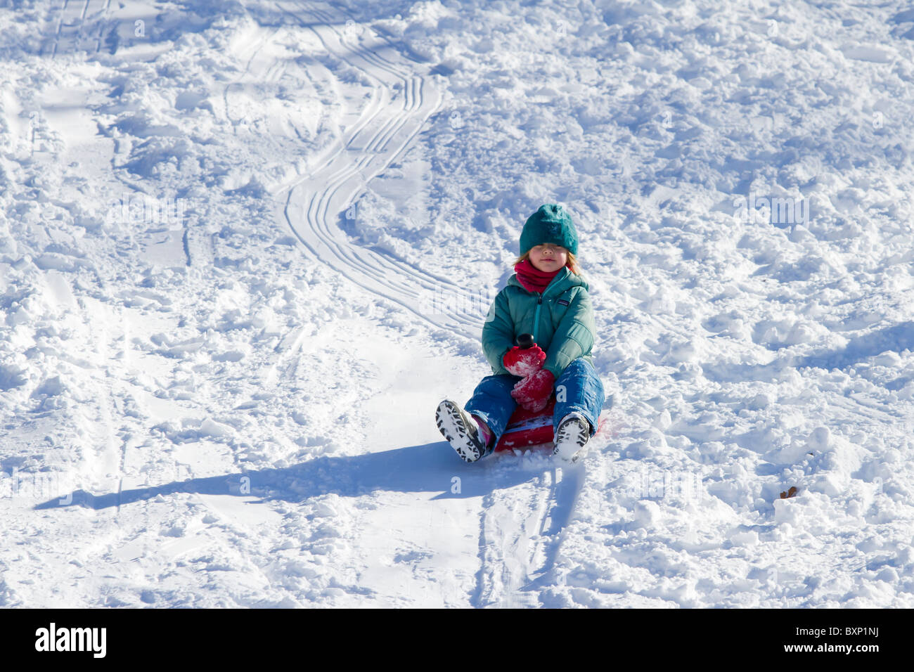 A young girl on her sled nears the bottom of the hill in Riverside Park ...