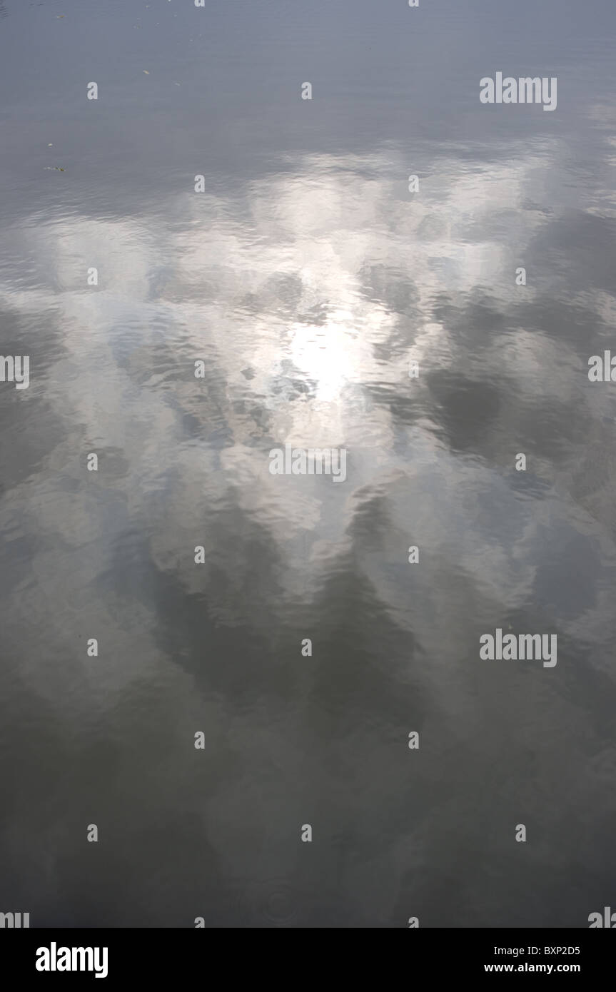 Sun and clouds reflections over a lake Stock Photo - Alamy
