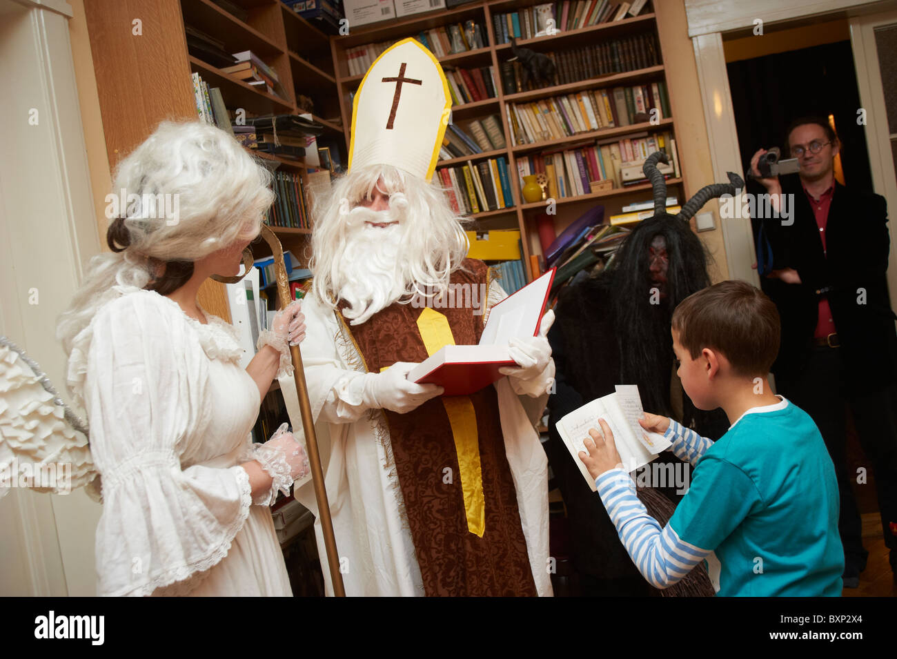 St. Nicholas Angel Devil visits children at home Stock Photo - Alamy