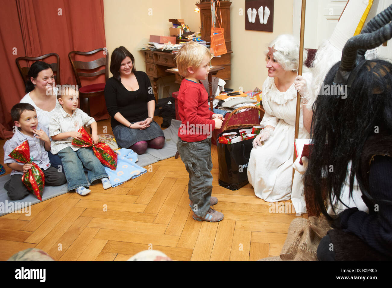 St. Nicholas Angel Devil visits children at home Stock Photo - Alamy