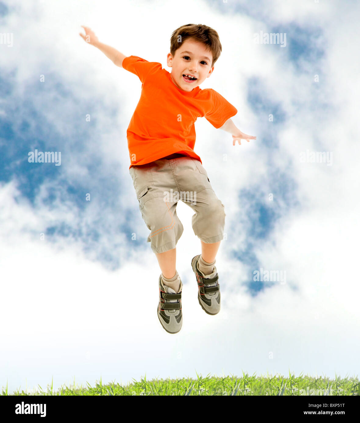 Photo of young boy jumping and raising hands in outside Stock Photo - Alamy