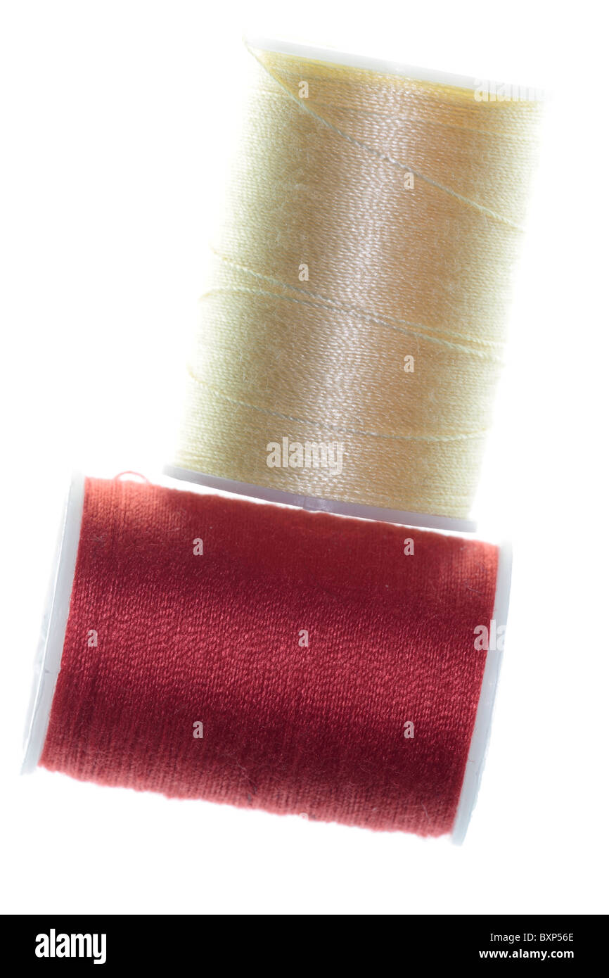 red and cream coloured cotton reels in close-up Stock Photo - Alamy