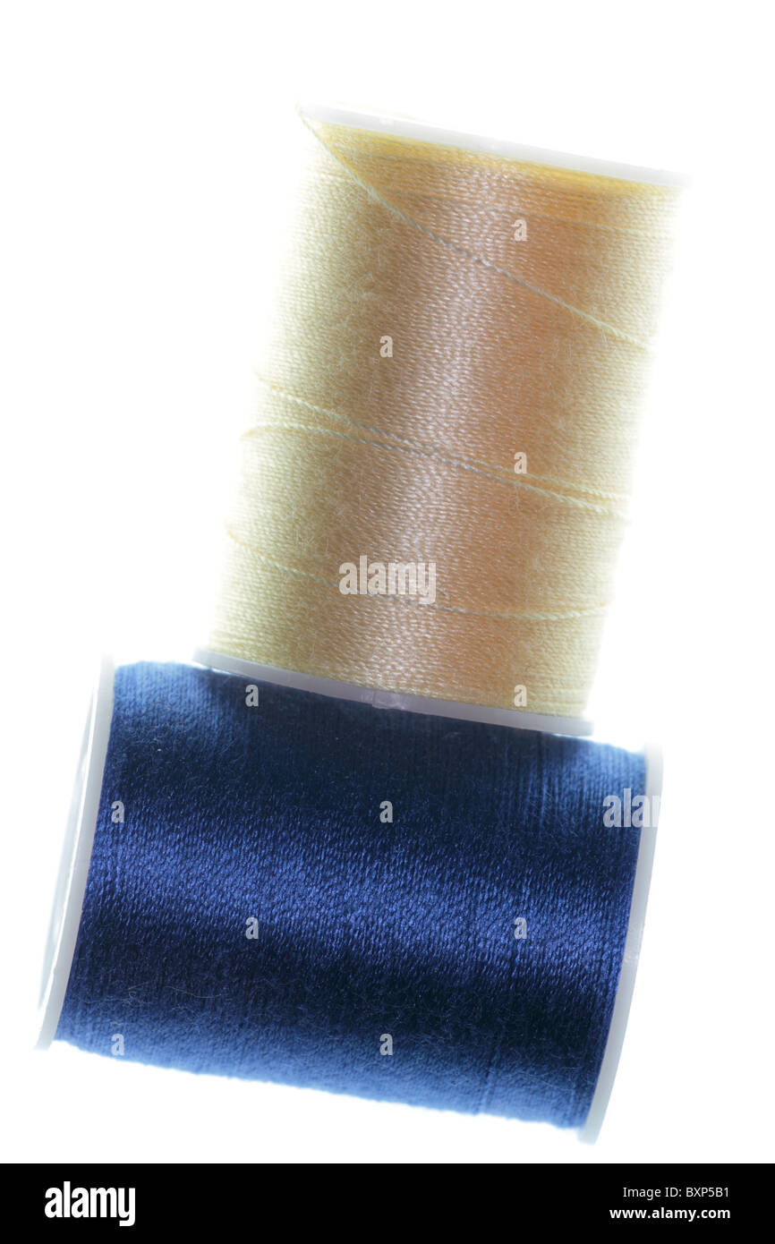blue and cream coloured cotton reels in close-up Stock Photo - Alamy