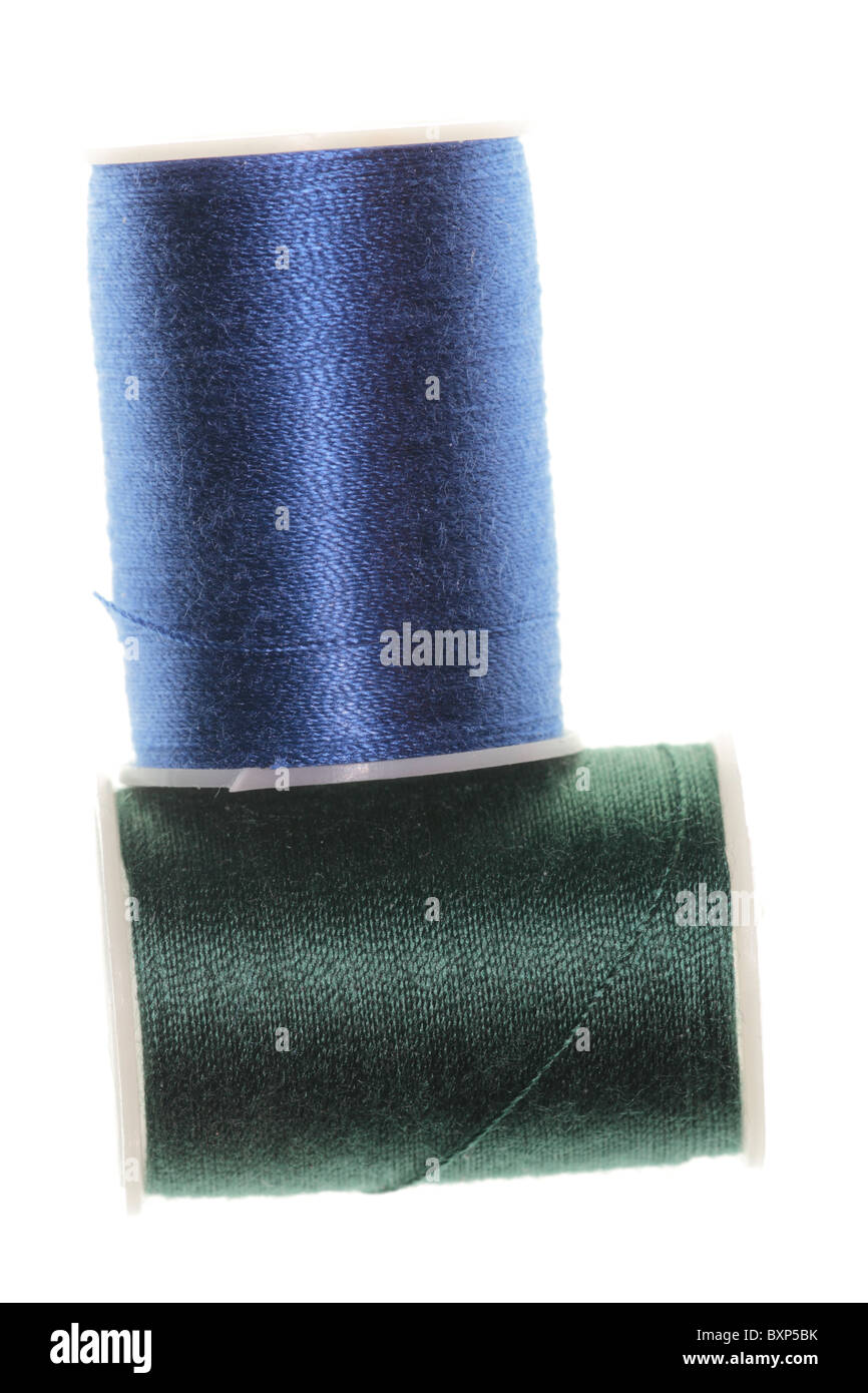 blue and green coloured cotton reels in close-up Stock Photo - Alamy