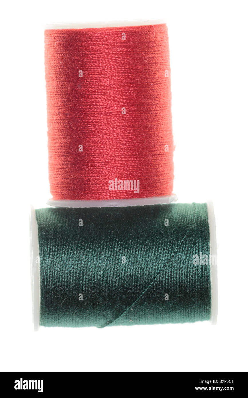 red and green coloured cotton reels in close-up Stock Photo - Alamy