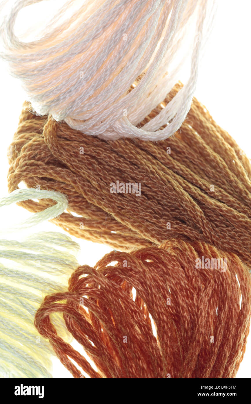 White, gold and amber coloured cotton thread Stock Photo - Alamy