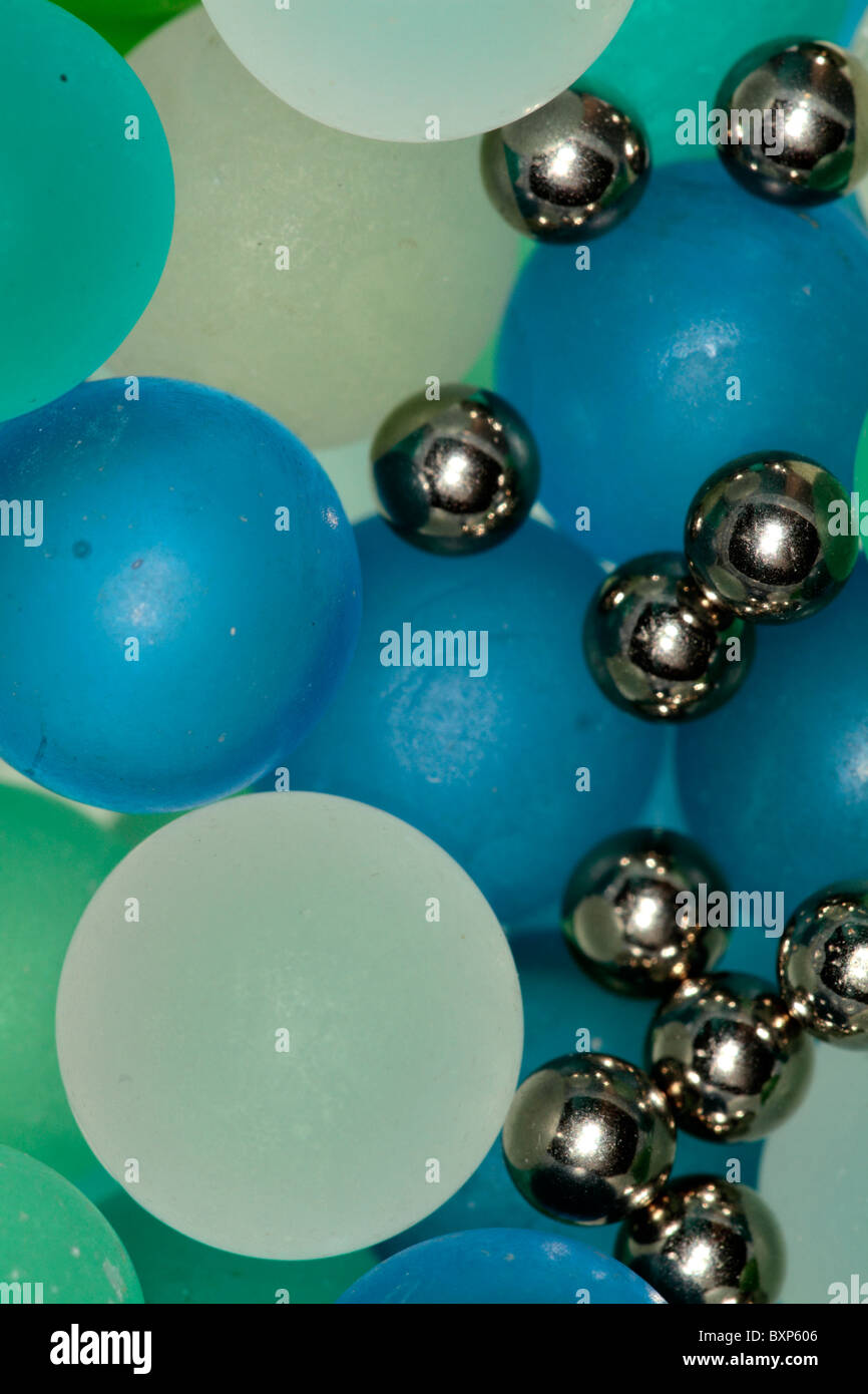 Pale blue and green marbles, ball bearings in close-up Stock Photo - Alamy