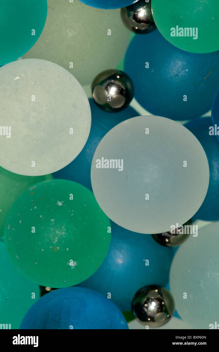 Pale blue and green marbles, ball bearings in close-up Stock Photo - Alamy