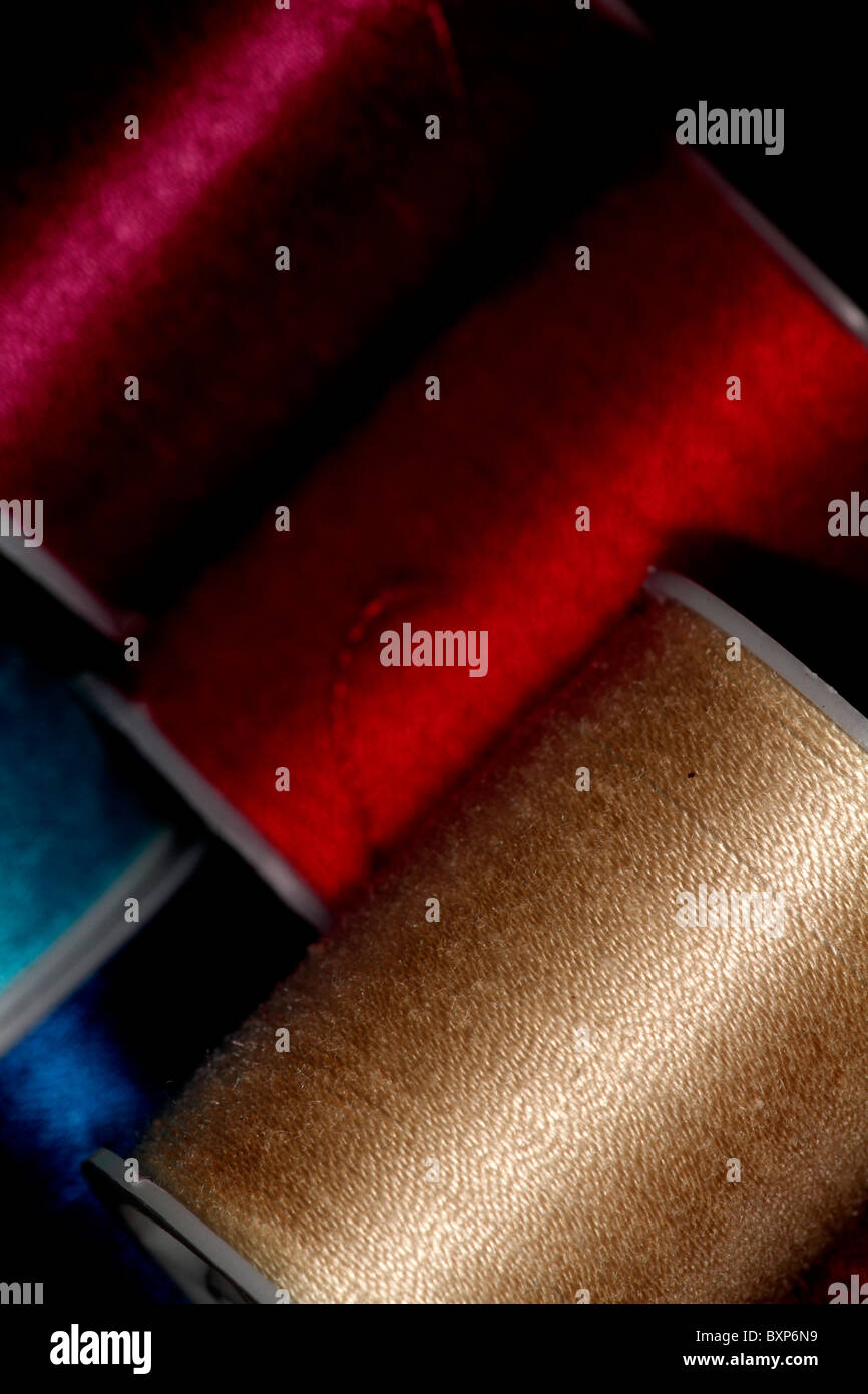 blue red and gold coloured cotton reels in macro Stock Photo - Alamy