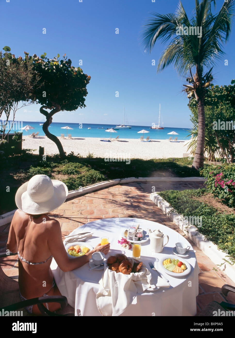 Female Tourist Eating Breakfast Outside On The Beach Stock Photo - Alamy