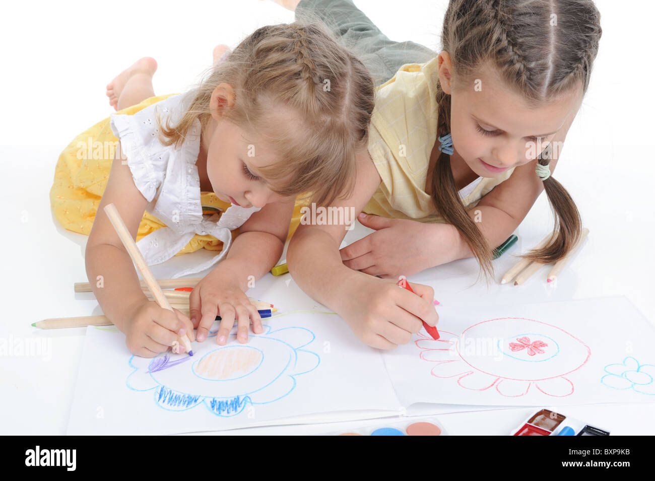 Two sisters draw on the album Stock Photo - Alamy