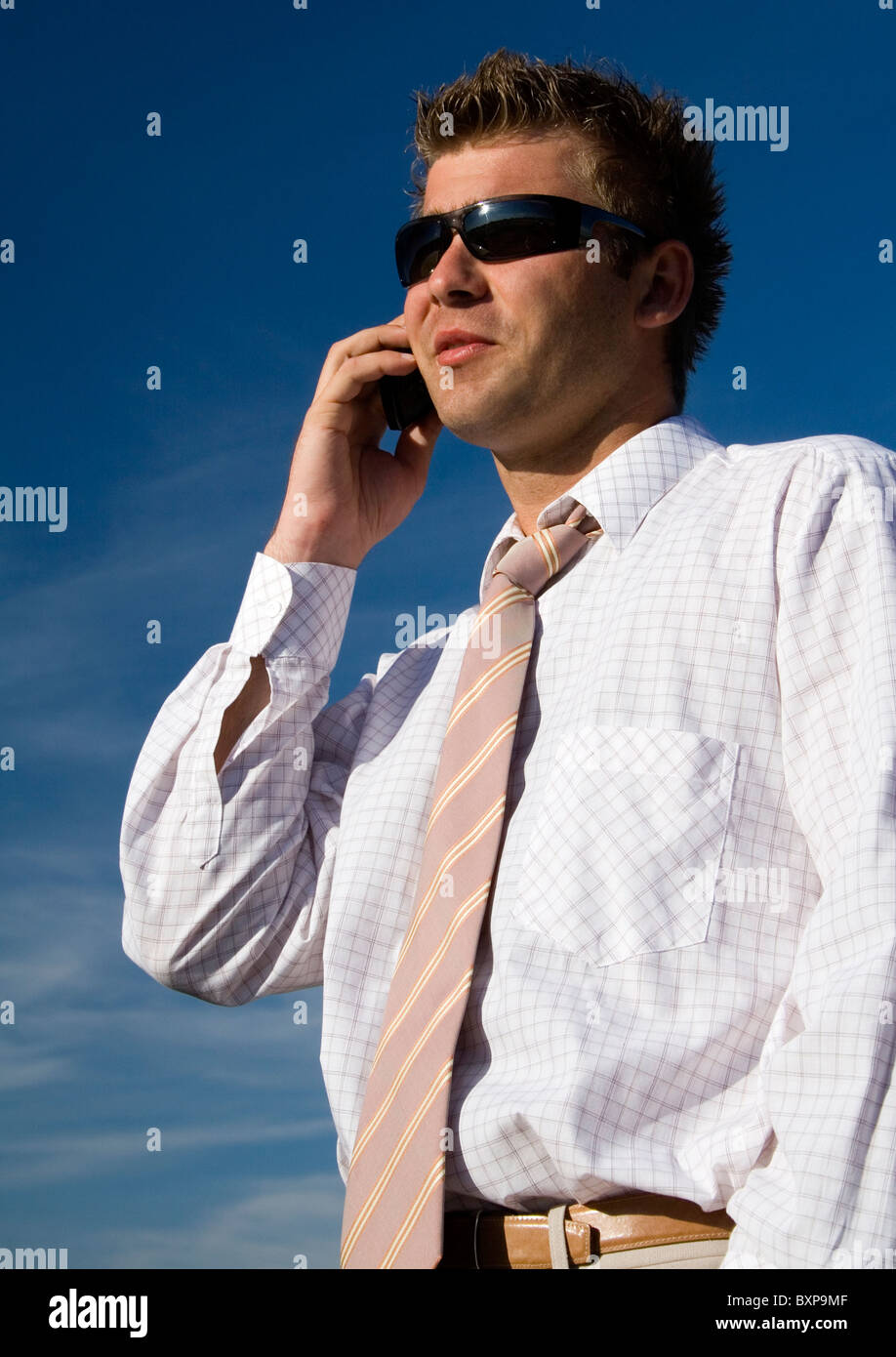 A businessman dressed in a smart suit standing on grass Stock Photo - Alamy