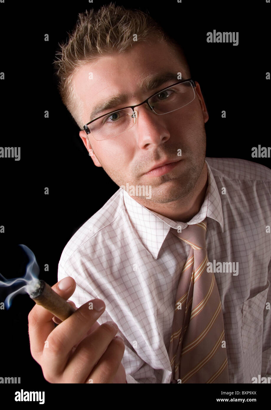 Businessman smoking cigar Stock Photo - Alamy