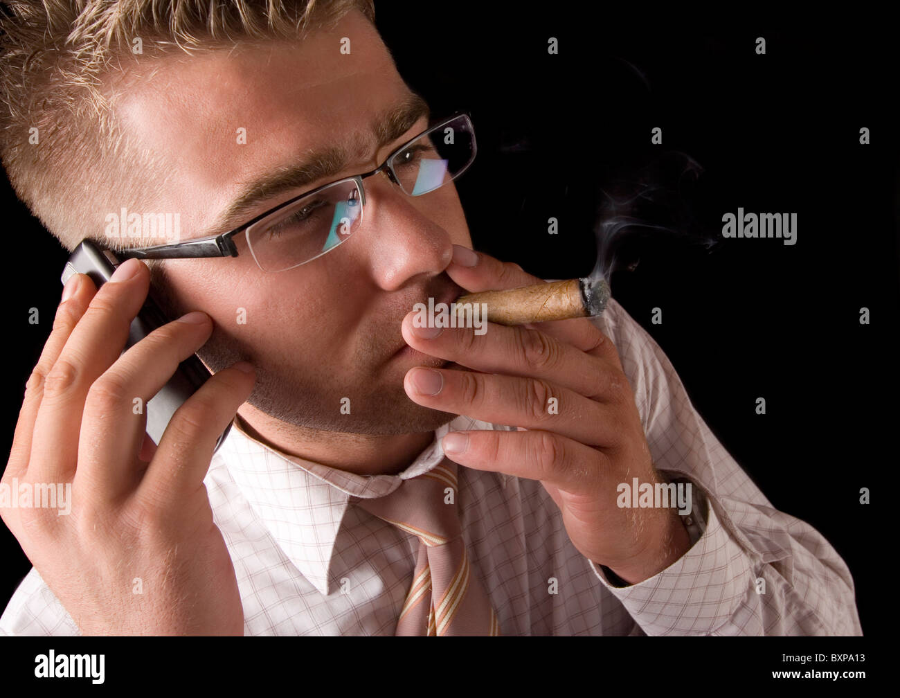 Businessman smoking cigar Stock Photo - Alamy