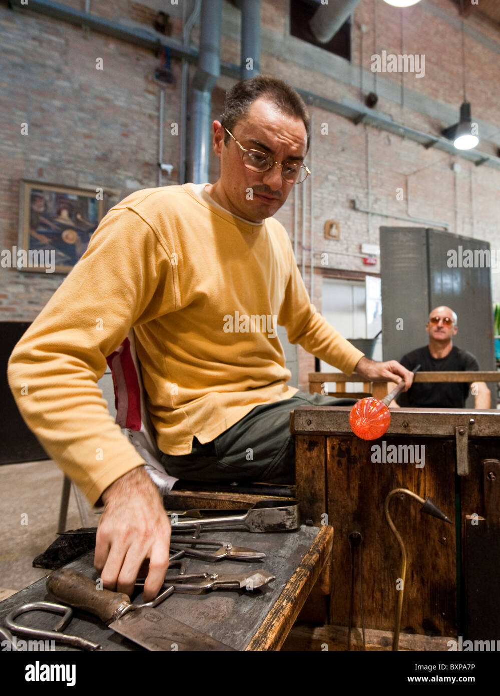 A maestro glassmaker at work in a glass factory in Murano Italy Stock ...