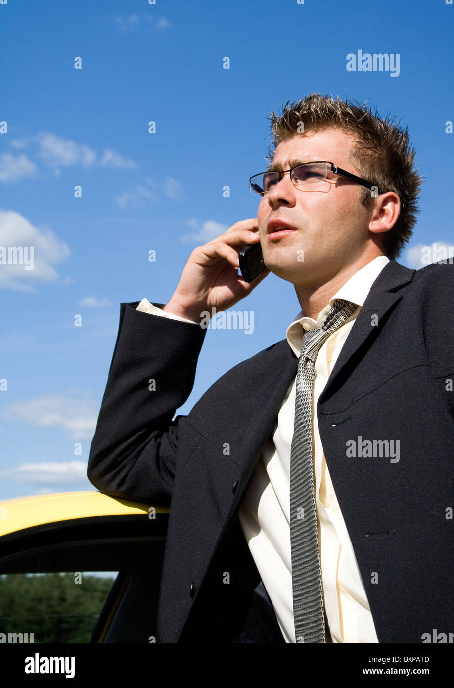 A businessman dressed in a smart suit standing on grass Stock Photo - Alamy