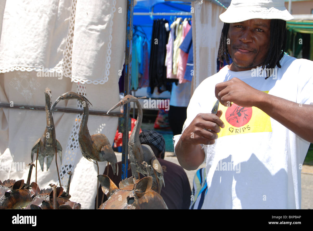 African artist/craftsman sells his goods at Green Point Market, Cape ...