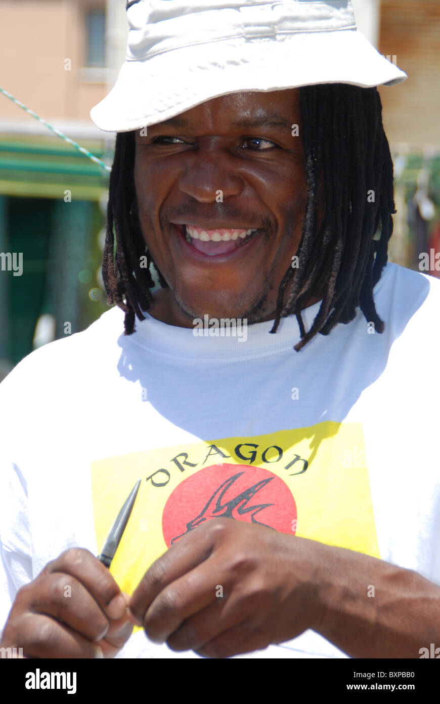 African artist/craftsman sells his goods at Green Point Market, Cape ...